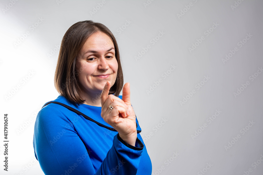 It is too small. Beautiful woman gesturing small size with her fingers ...