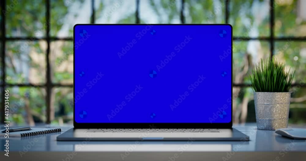 Vidéo Stock Frameless laptop with blank blue screen on desk in loft ...
