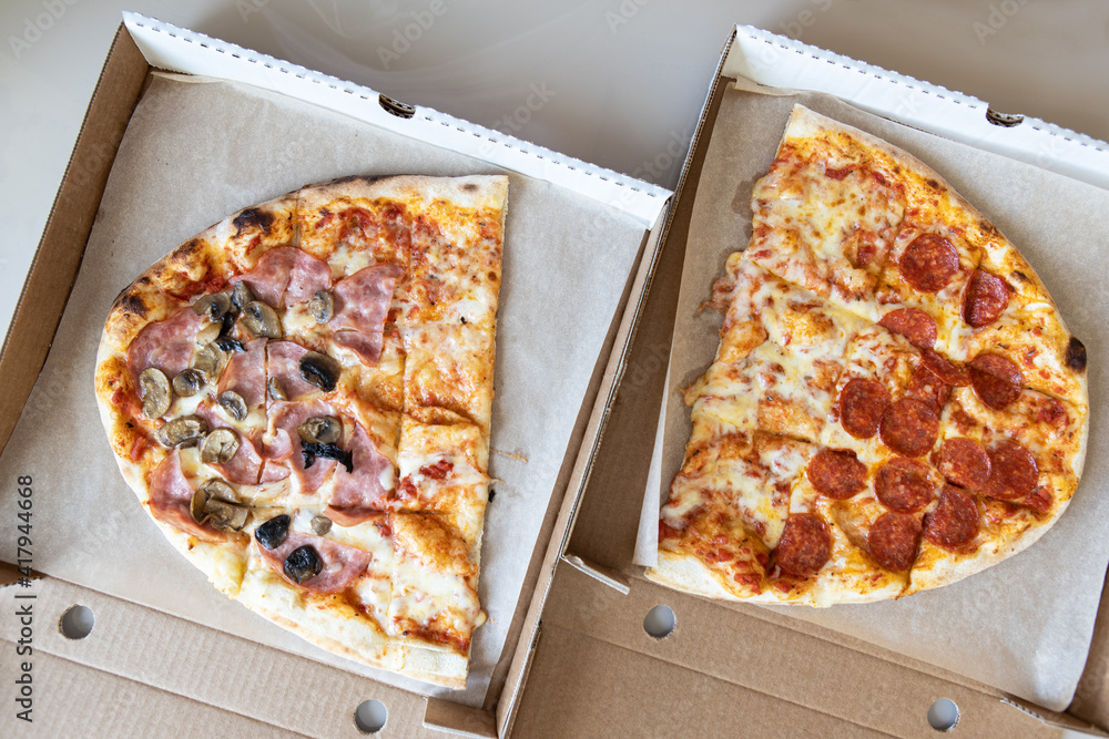 Family pizza, oval, divided into two halves, consists of three types ...