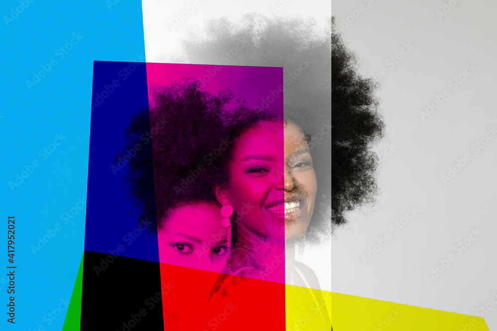 Smiling Afro woman with primary colors against white background Stock ...