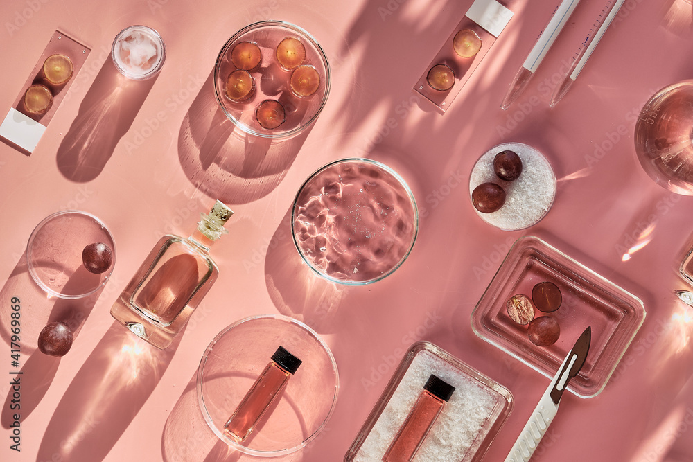 Cosmetic skincare background with red grapes. Abstract pink flat lay ...