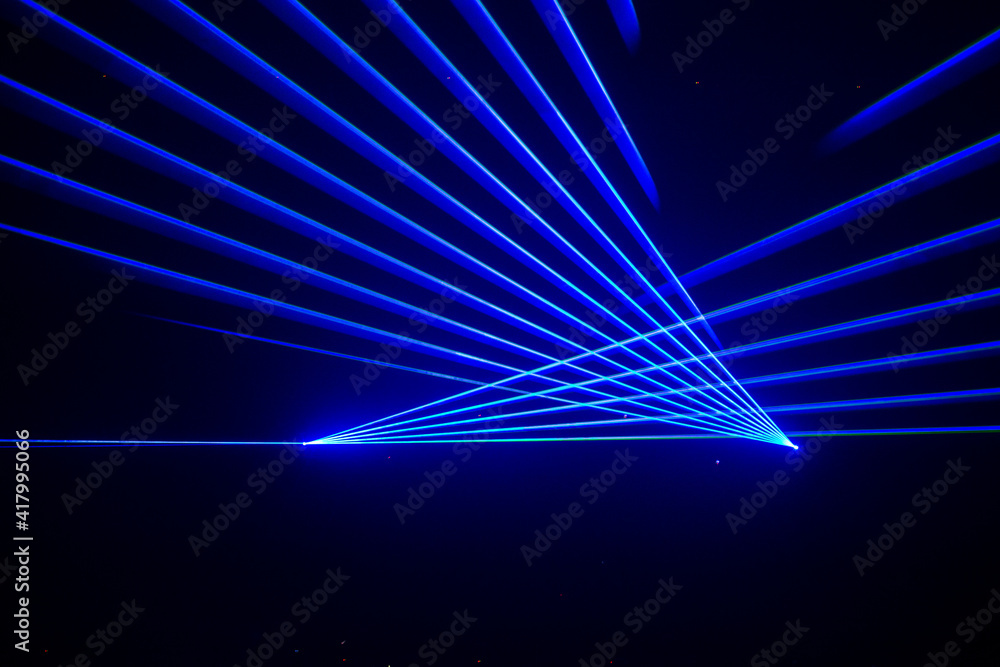 Beautiful blue laser beam in concert with crowded people holding the ...