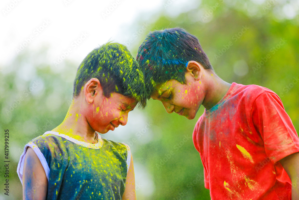 Cute indian little child playing holi. Holi is colors festival in india ...