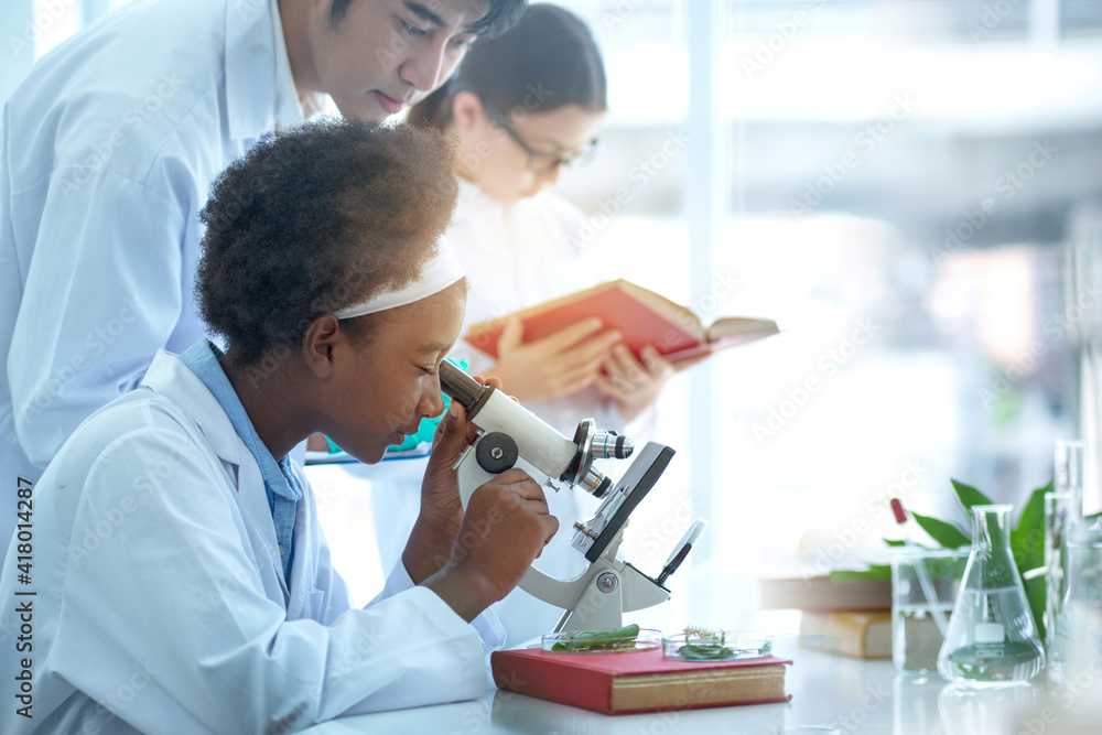 Different types of skin student working in a science class with his ...