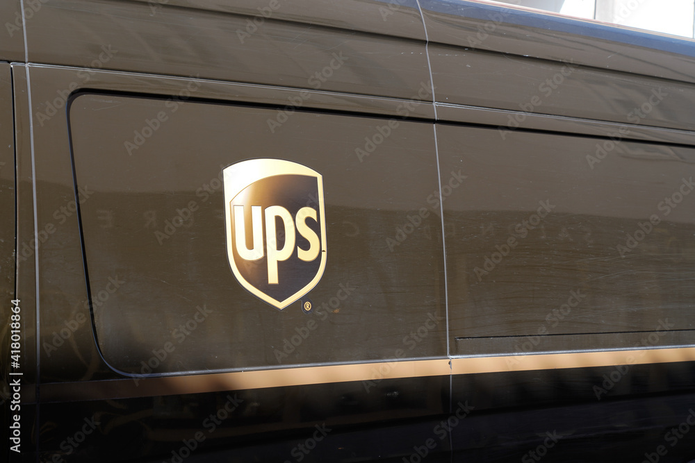 UPS Delivery Truck van with logo and brand sign on panel in street to ...