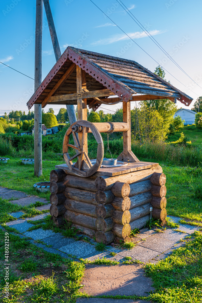 A rustic wooden well helps pilgrims drink water. Holy Trinity Alexander ...