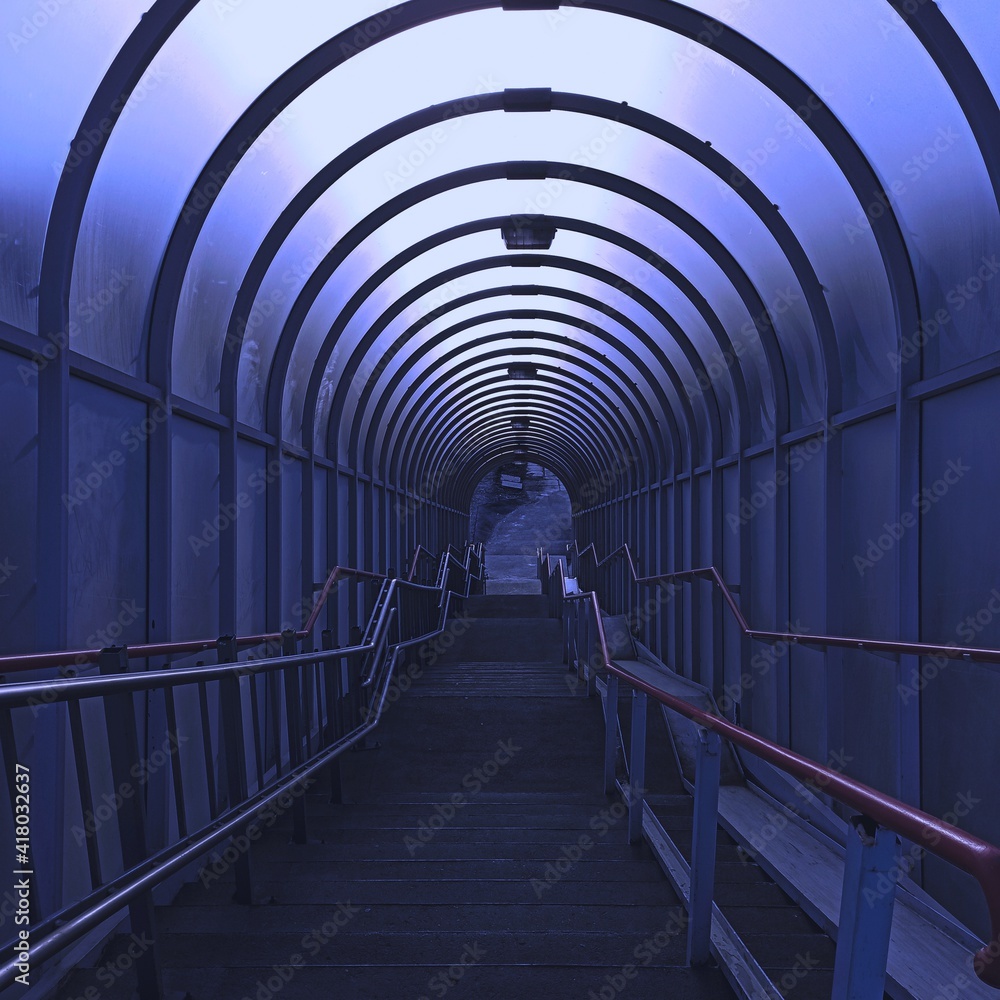 Arched corridor. Round tunnel. Ladder down. A light in the end of a ...