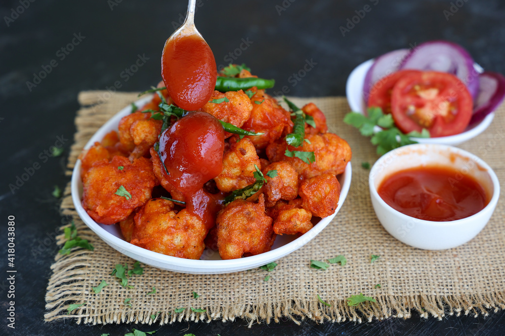 Gobi Manchurian dry, pouring tomato sauce on Gobi 65 popular Indian ...