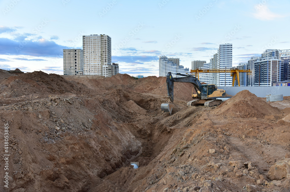Excavator dig the trenches at a construction site. Laying concrete ...