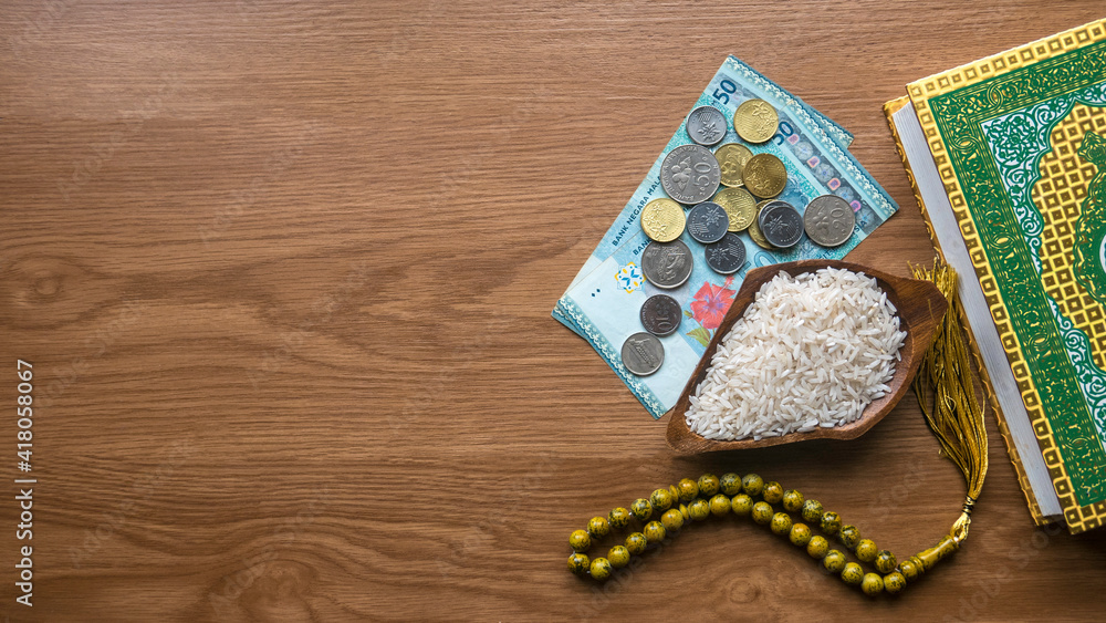 Concept of zakat in Islam religion. Top view of money, rice, Koran and ...
