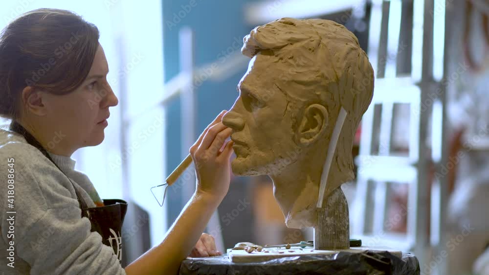 Woman sculptor at work. The process of preparing clay sculpture for ...