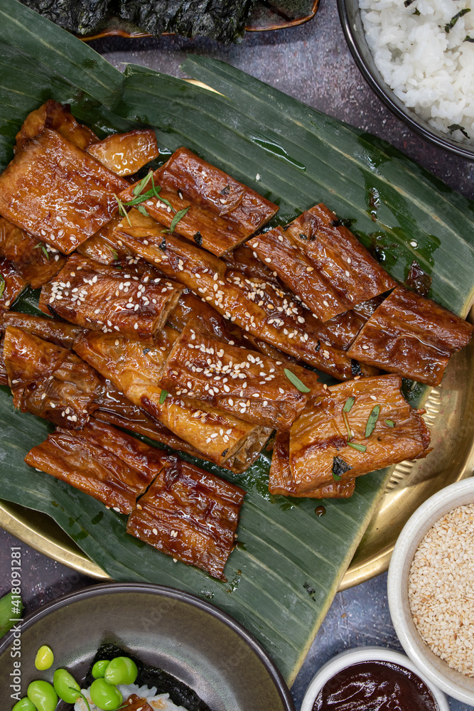 Tofu skins yuba rolls glazed and roasted, served with rice, edamame ...