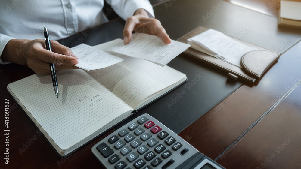 Woman with bills and calculator. Woman using calculator to calculate ...