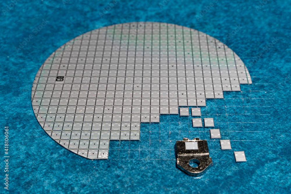 High-power transistor chip on a silicon wafer. Stock Photo | Adobe Stock