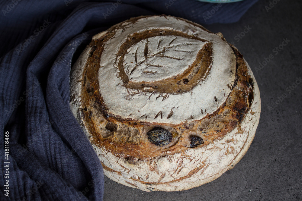 Sourdough bread with a leaf pattern on the top. Whole grain bread with ...
