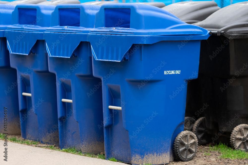 Foto de Large blue plastic garbage trash bins with sign recycling only ...
