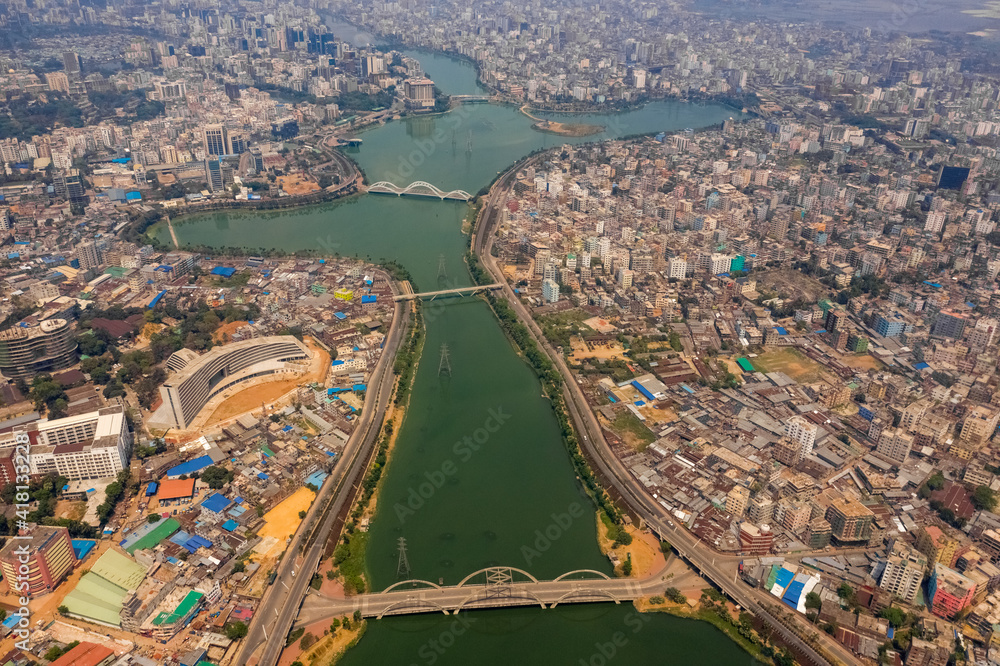 Aerial view of Hatir Jheel lake in Dhaka city center with city skyline in background, Dhaka ...