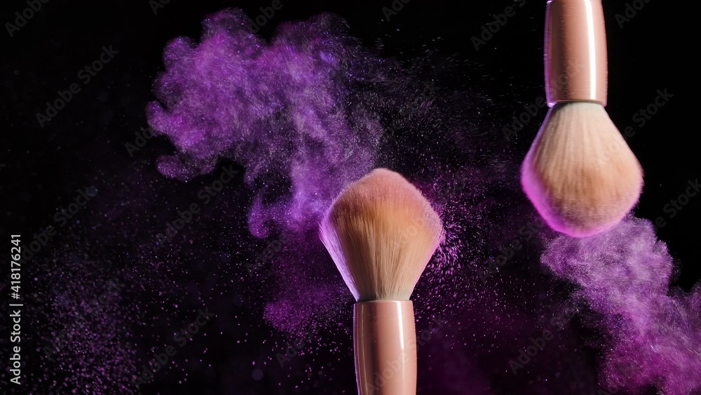 From the touch of two makeup brushes, colorful glittering powder or ...