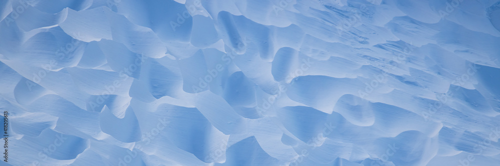 Snow texture. Wind sculpted patterns on snow surface. Wind in the ...