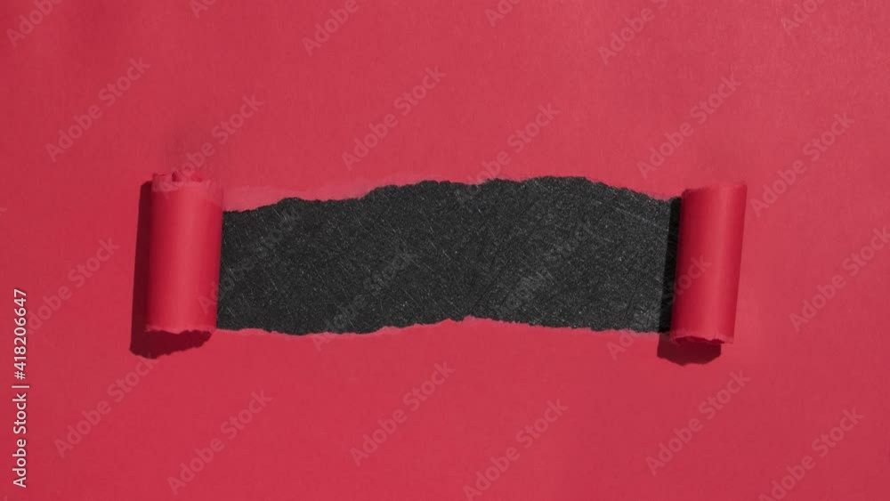 Red paper opening ripping to reveal black copy space. Paper ripping ...