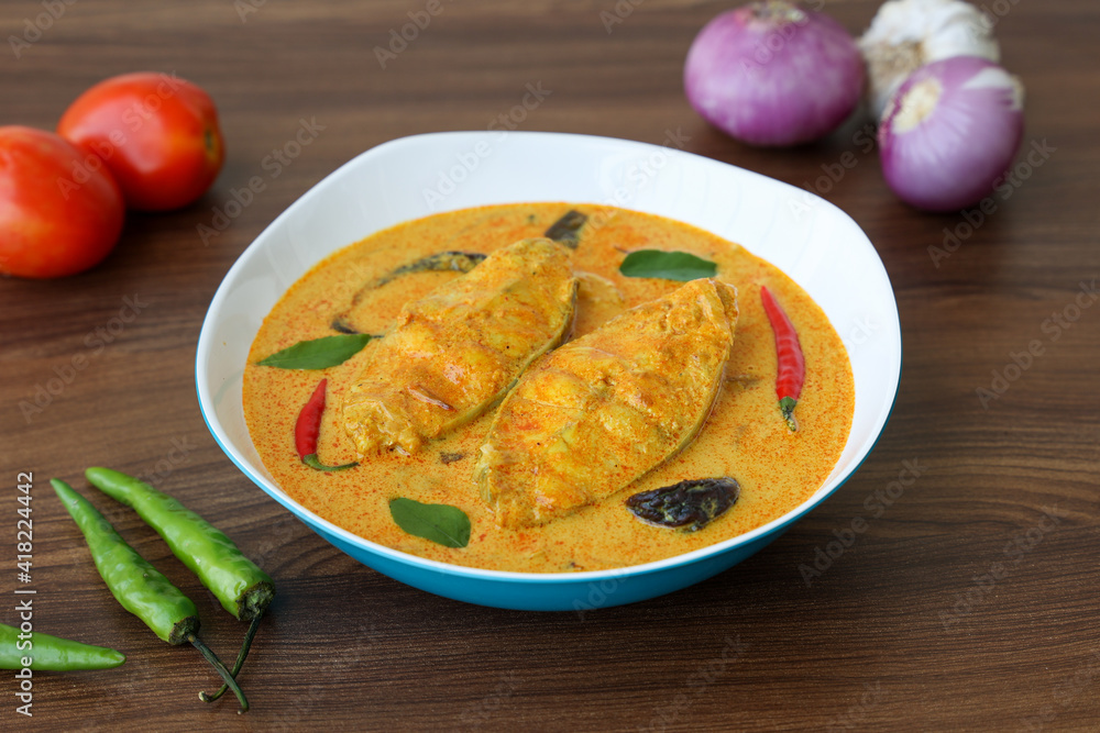 Kerala fish curry coconut milk gravy , cooking spicy Goan fish curry ...