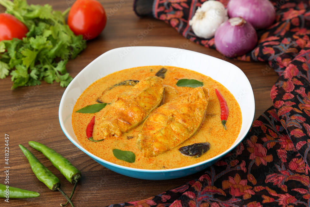 Kerala fish curry coconut milk gravy , cooking spicy Goan fish curry ...