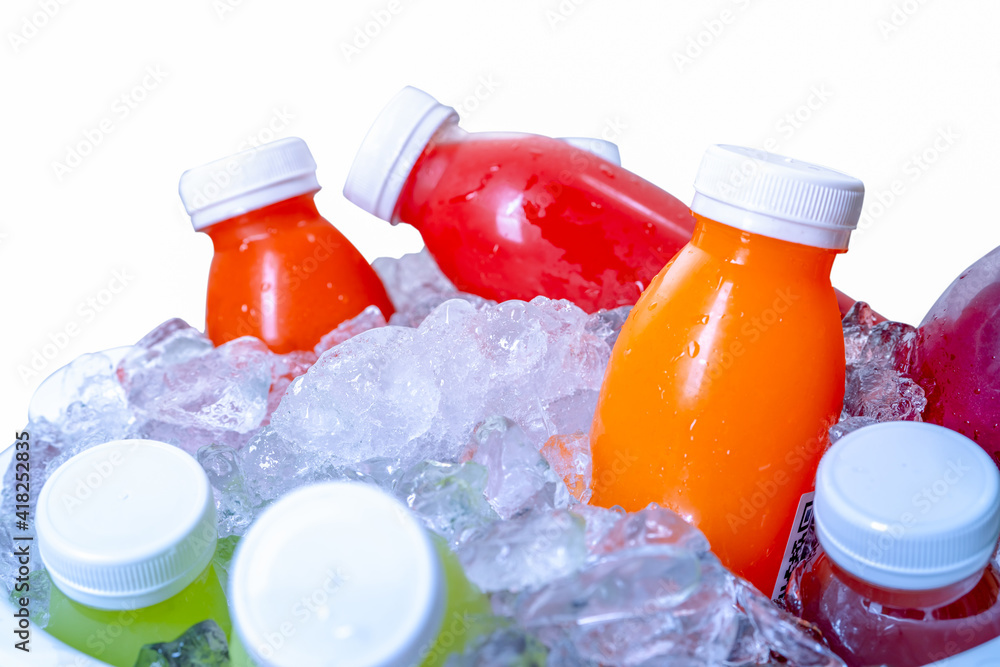 Organic cold pressed raw vegetable and fruit juice bottle in crushed ...