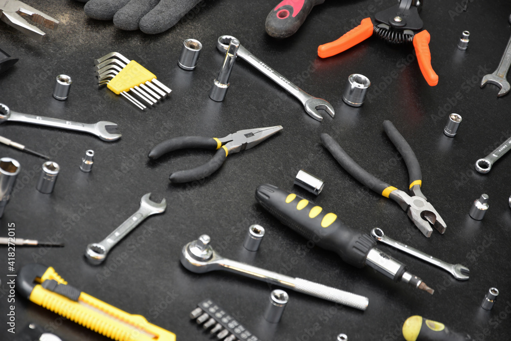 Foto de Handyman tool kit on black wooden table. Many wrenches and ...