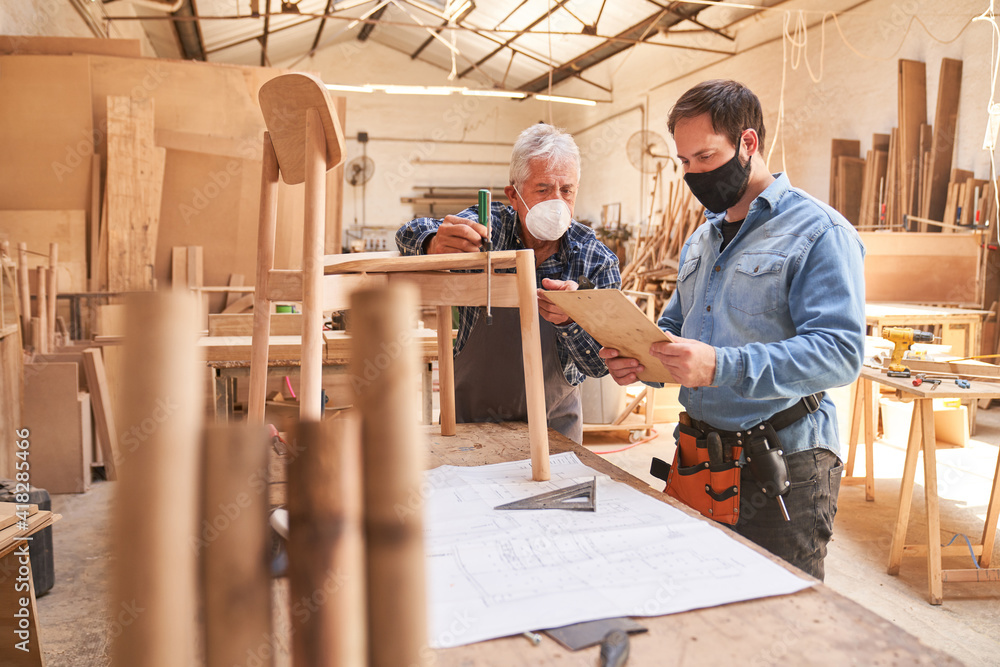 Two craftsmen with face masks as cabinet makers Stock Photo | Adobe Stock