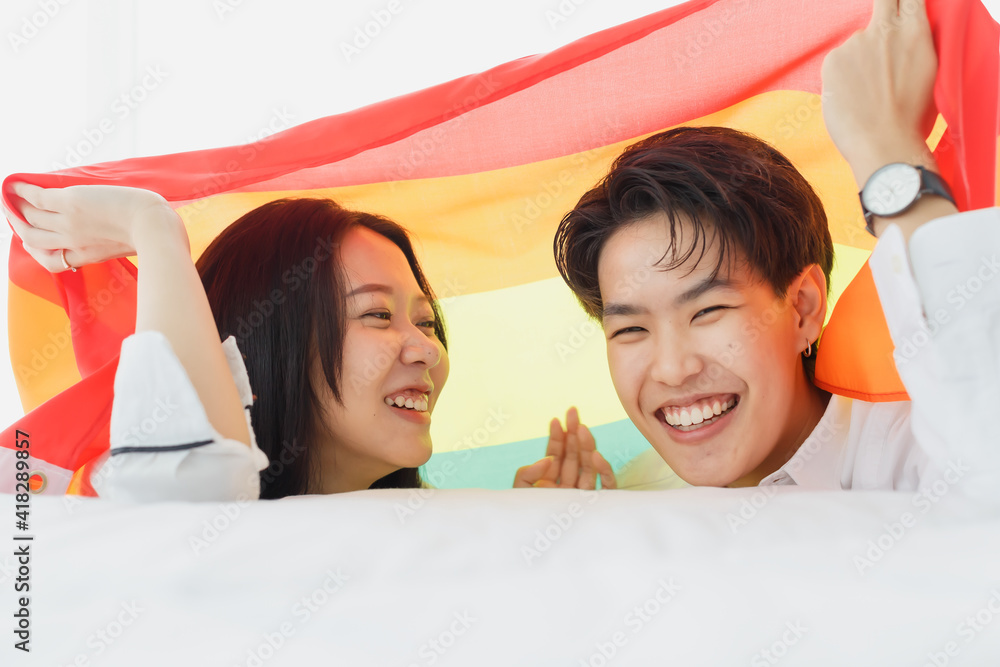 LGBTQ couple lovers, a handsome girl as a man or butch femme covered ...