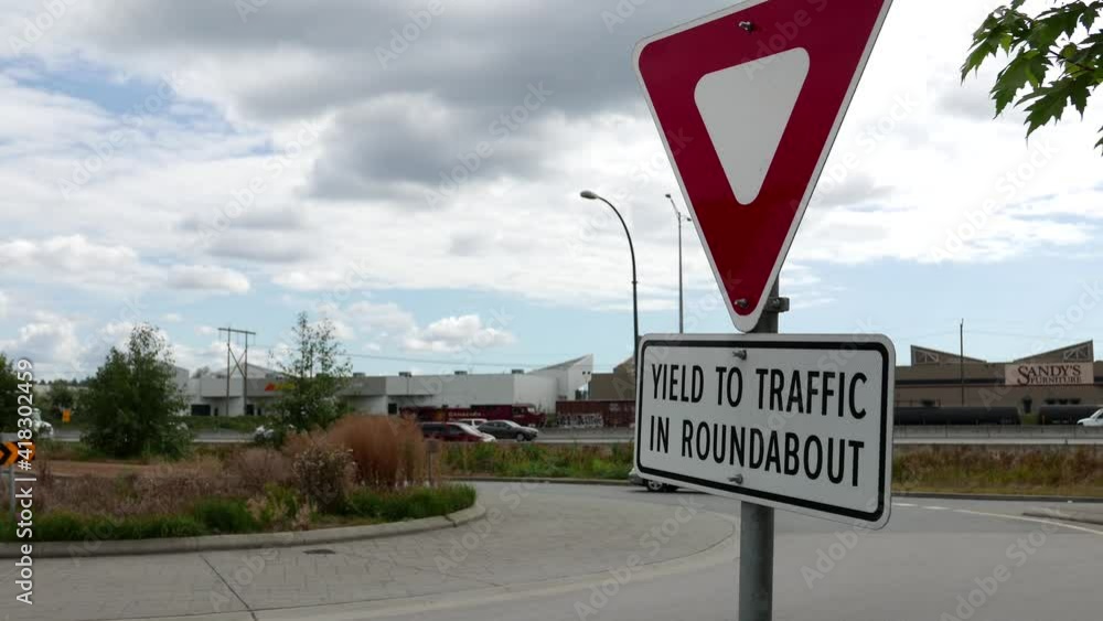 The motion of yield to traffic in roundabout sign with traffic flow ...