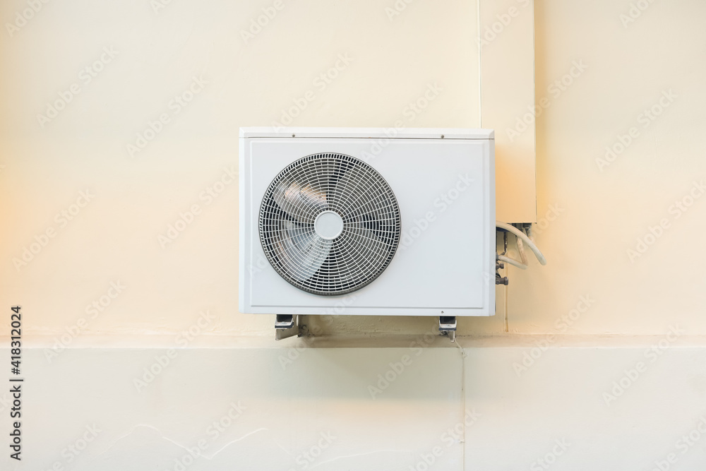 Condenser unit or compressor outside home or residential building. Unit ...