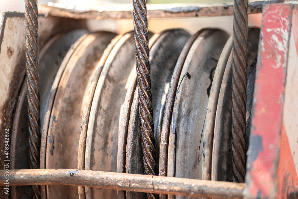 Wire rope sling and crawler drum of the lifting crane machine. Close-up ...