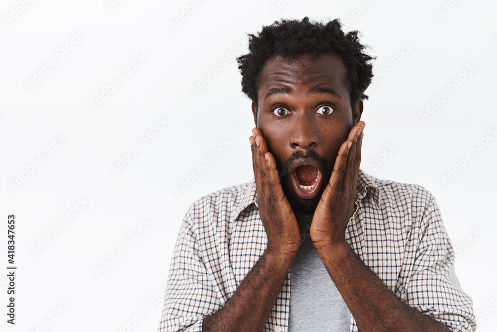 Surprised, speechless handsome african-american guy, gasping and scream ...
