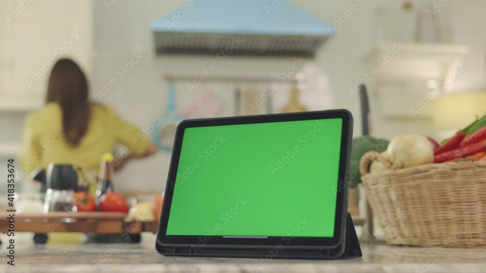 Tablet with a green screen With a beautiful background Cooking in the ...