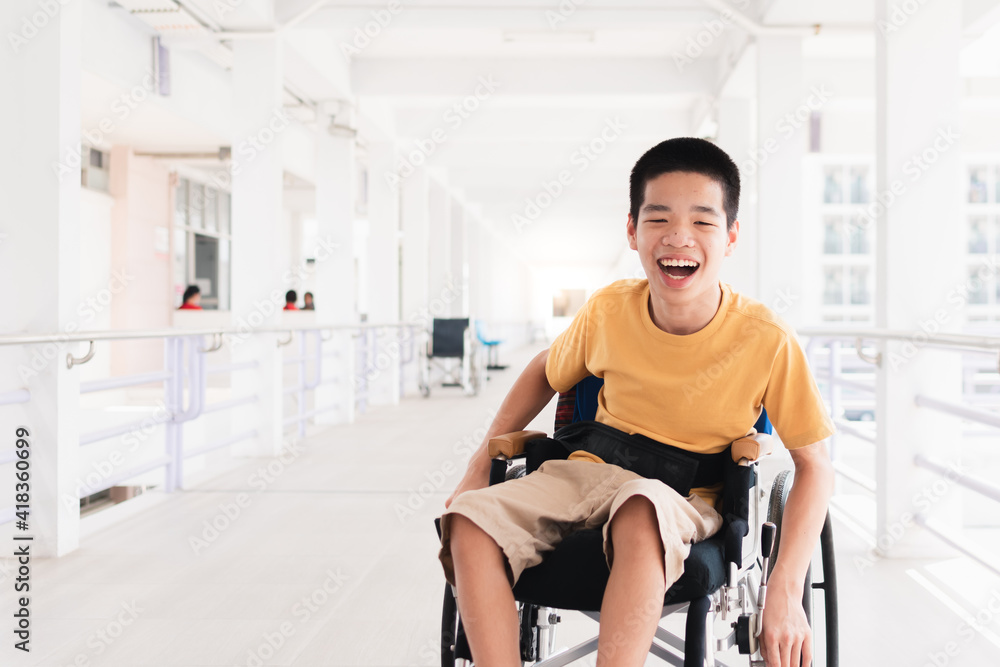 Asian special child on wheelchair is smiling face as happiness on ramp ...
