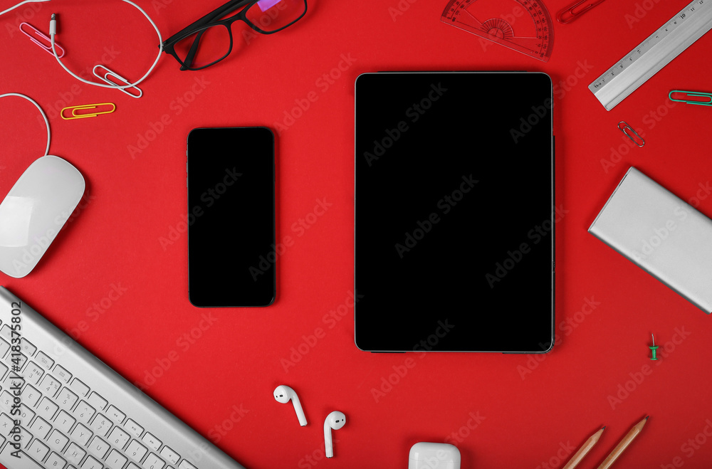 Mockup of smart gadgets on the background of office items on red ...