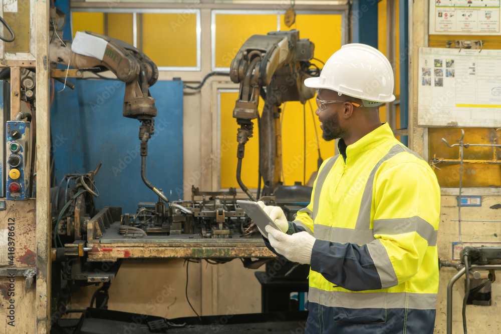 Black African American man, an engineer or worker use tablet device to ...