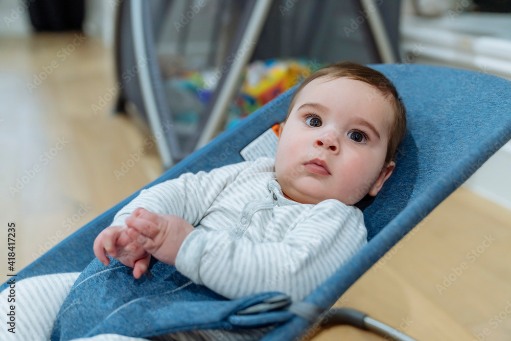 Cute baby boy hanging out in rocker chair Stock Photo | Adobe Stock