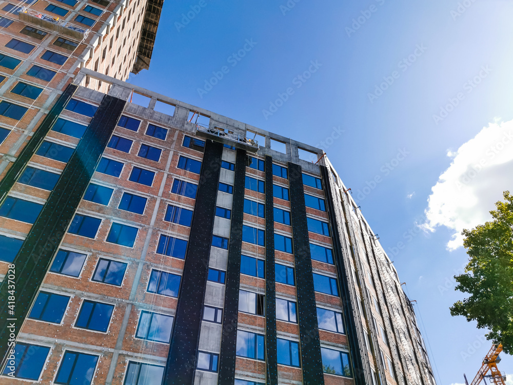 Scaffolding and installation of glass facade panels to a new building ...