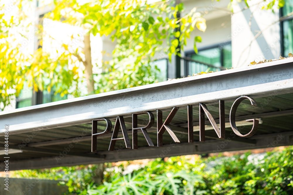 "Parking" text sign in black metal object on the indoor roof structure ...