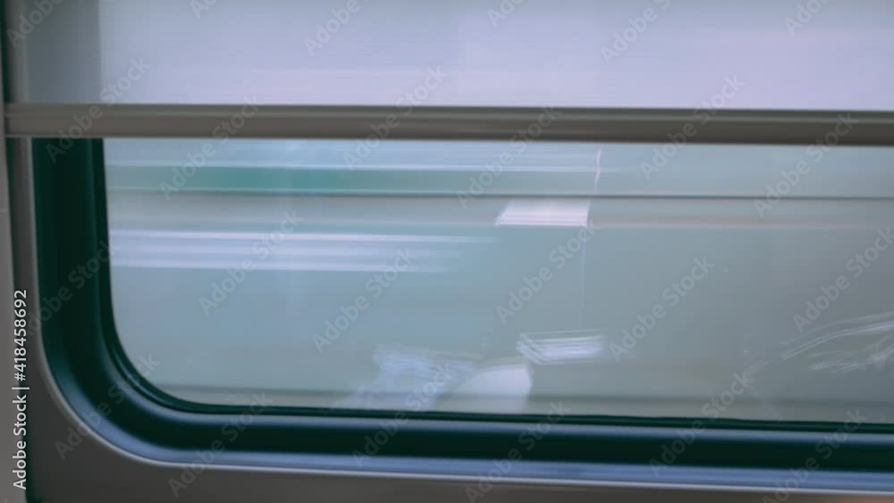 Through the window of a passenger train, one can see how railway ...