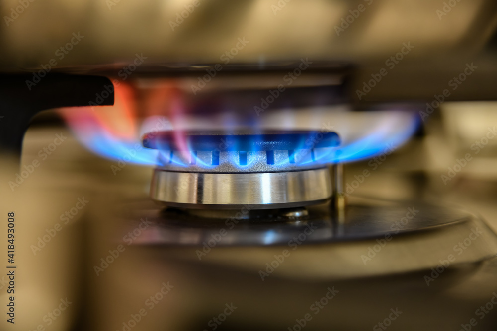 Combustion of household gas on a gas stove, gas energy saving concept ...