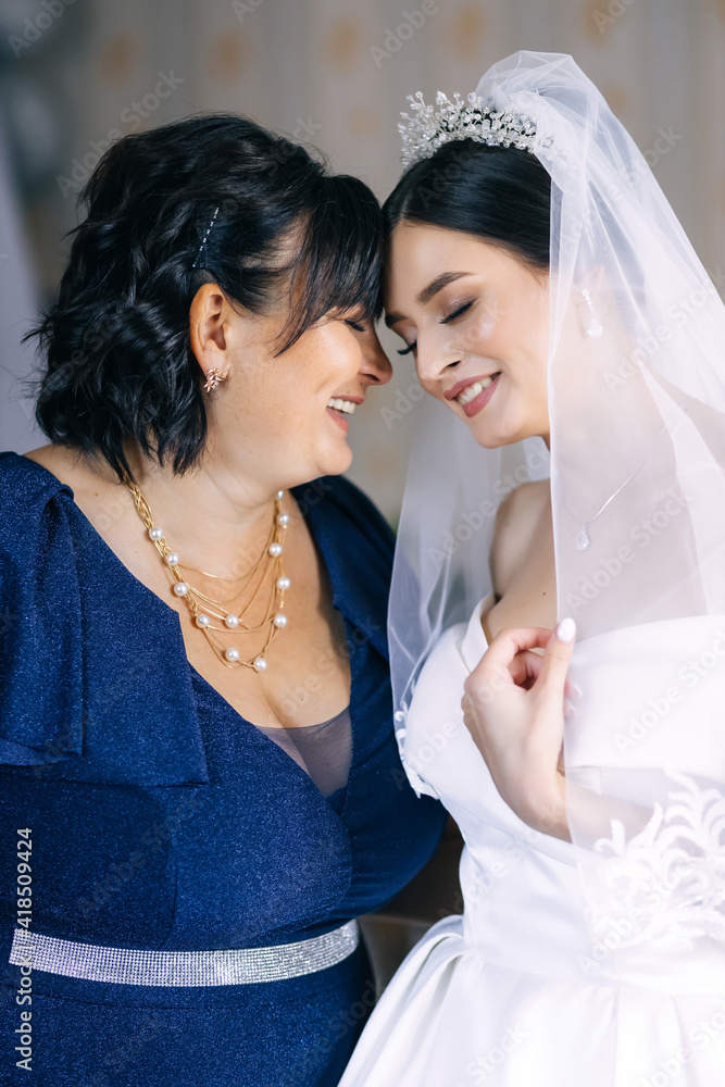 Wedding morning of the bride. The mother of the bride blesses the bride ...