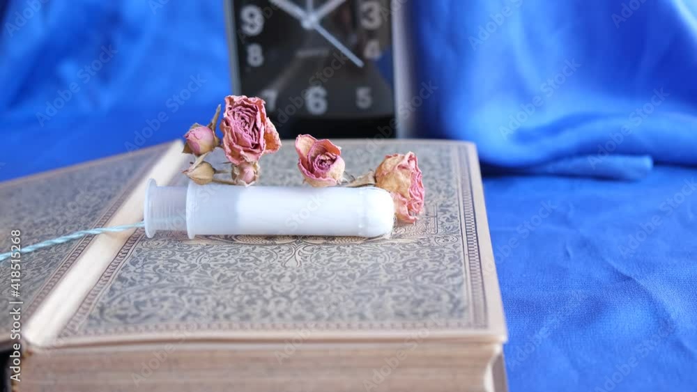 menopause concept. dried red rose lies on a woman tampon. dried rose ...