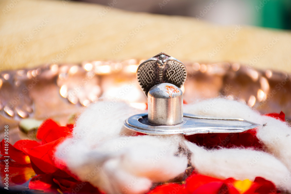 Stock photo of a silver shivlinga which is icon of lord shiva snake ...