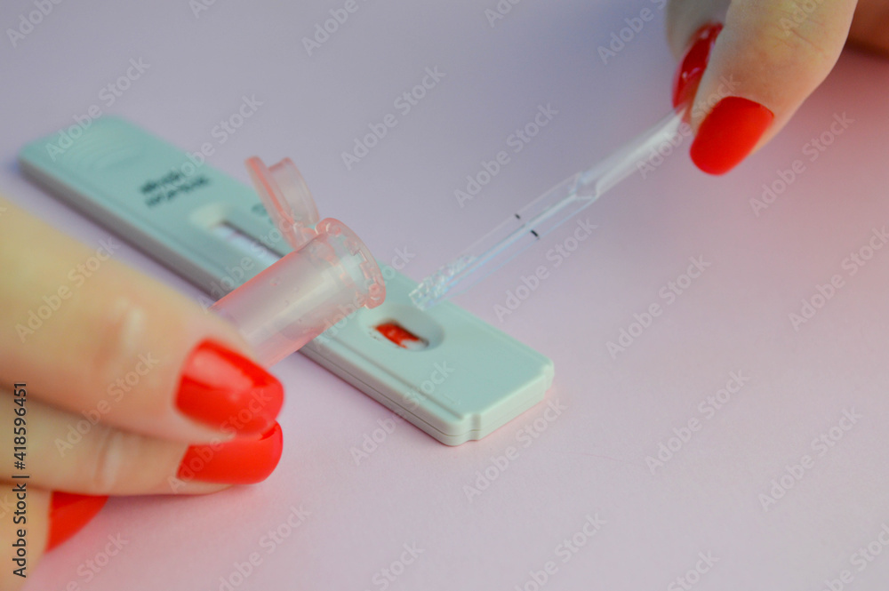 coronavirus test on a pink matte background. medical procedure. pink ...