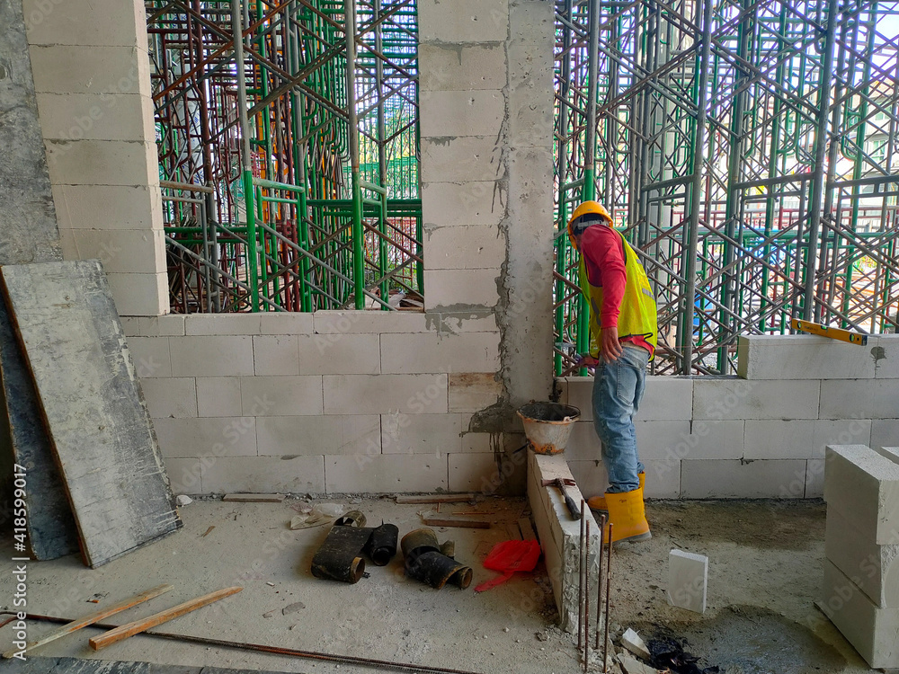 SEREMBAN, MALAYSIA -MARCH 15, 2020: Blockwork by construction workers ...