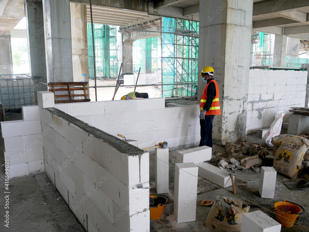 SEREMBAN, MALAYSIA -MARCH 15, 2020: Blockwork by construction workers ...
