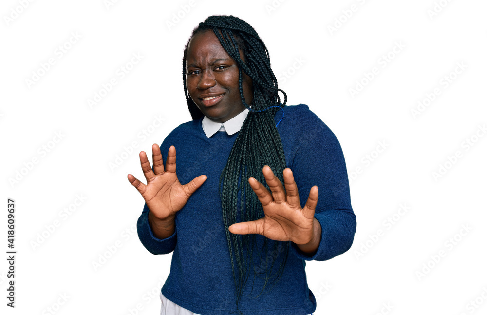 Young black woman with braids wearing casual clothes disgusted ...
